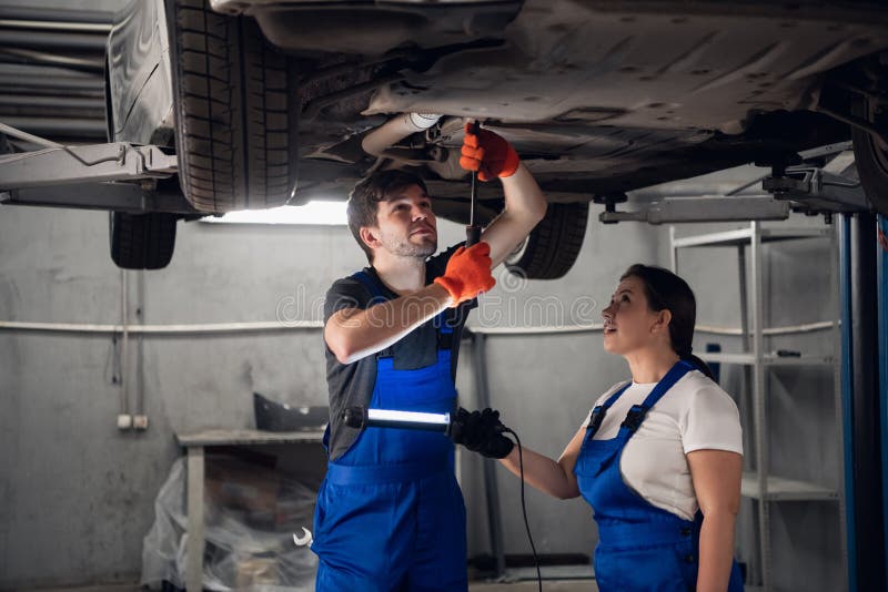 Techie and Mechanic Inspect Car with Torch Stock Image - Image of ...