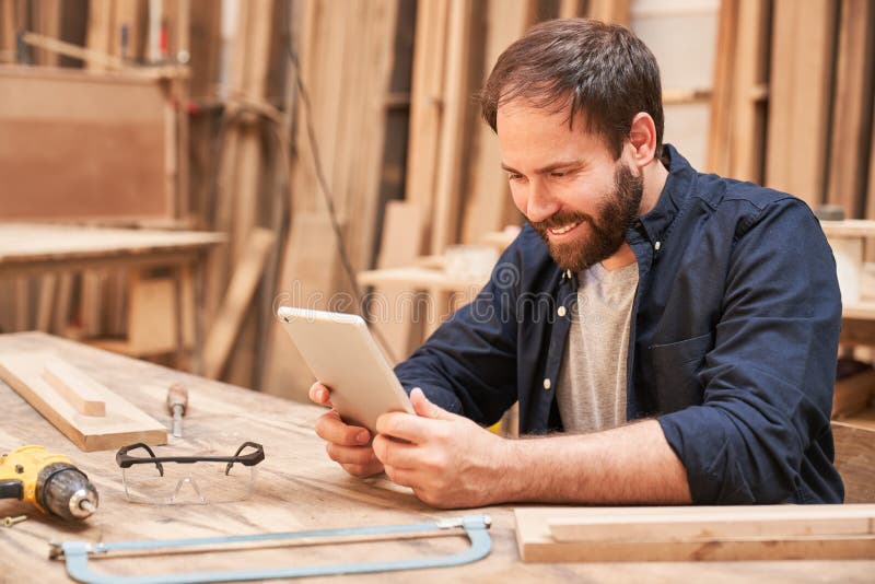 Handyman Reads Message on Tablet Computer Stock Image - Image of smile ...