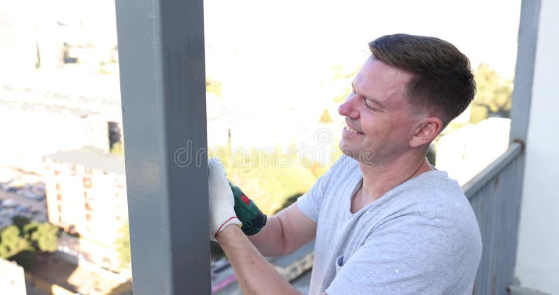 Handyman Repairs Balcony Railings and Removes Rust Stock Footage ...