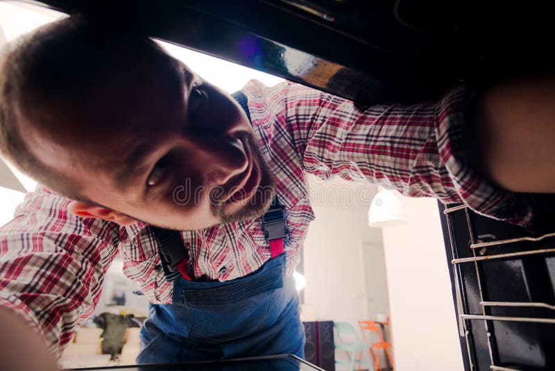 Handyman Searching the Problem in the Oven Stock Image - Image of ...