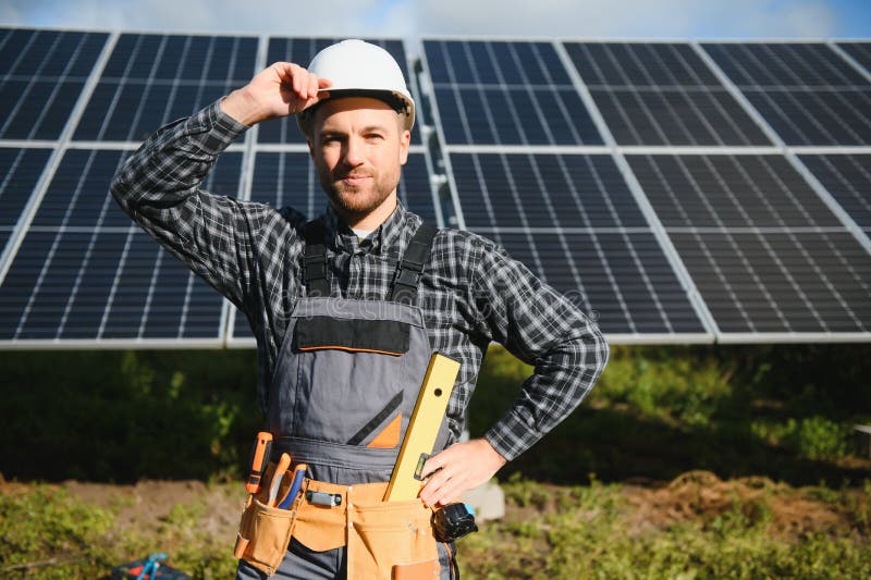 A Handyman Standing on the Rooftop with Solar Panels and Smiling at the ...