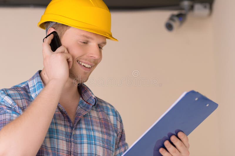 Handyman talking at phone. stock image. Image of manual - 32658059