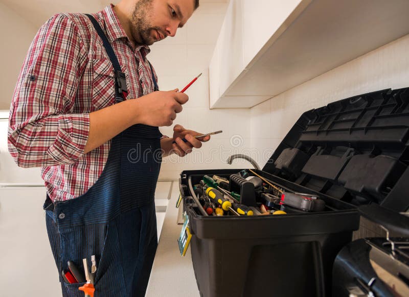 Handsome Guy Searching His Tool in the Kitchen Stock Photo - Image of ...