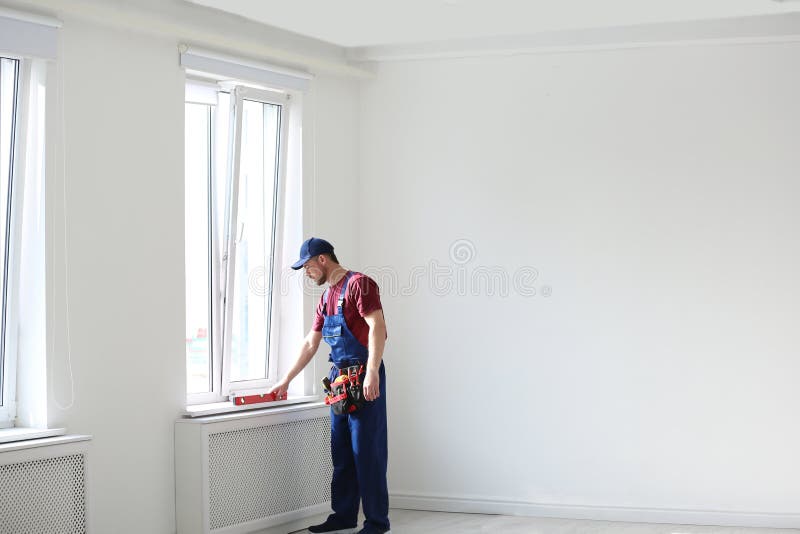 Handyman in Uniform Working with Building Level Indoors. Professional ...