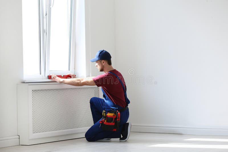 Handyman in Uniform Working with Building Level. Professional ...