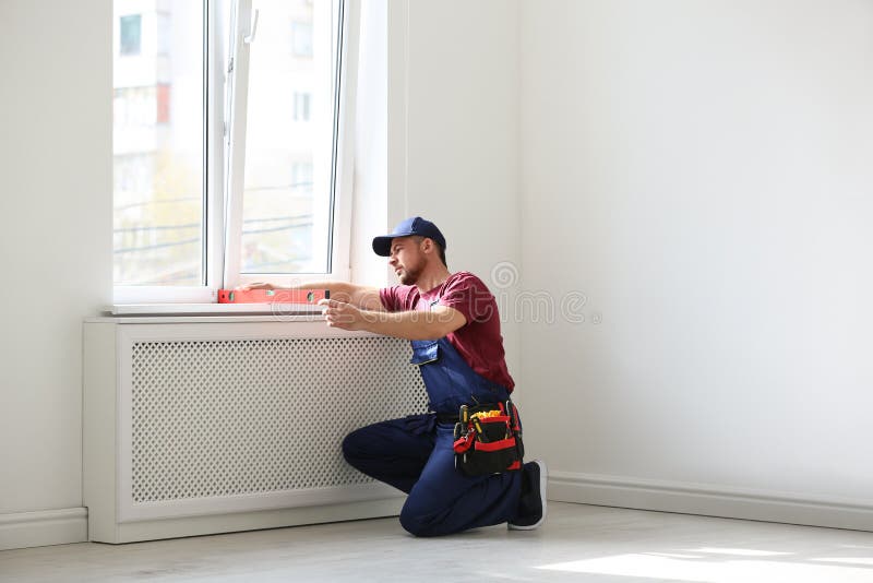 Handyman in Uniform Working with Building Level. Professional ...