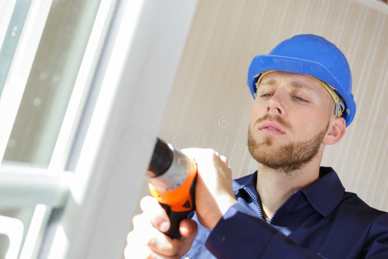 Handyman Using Cordless Screwdriver To Install Window Stock Photo ...