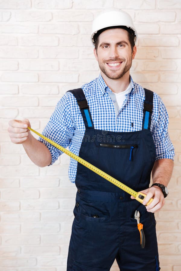Handyman Working Using Yellow Tape Indoors Stock Image - Image of ...