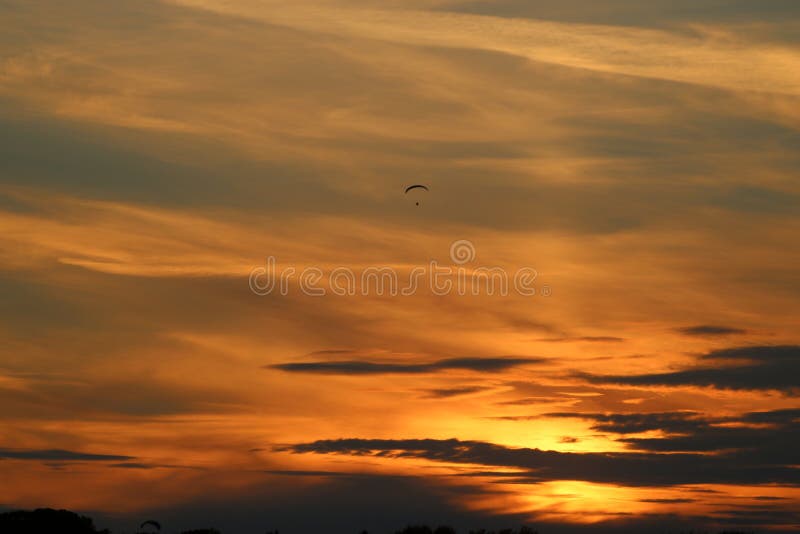 Hang Glider in Colored Sunset Sky Stock Photo - Image of colors ...