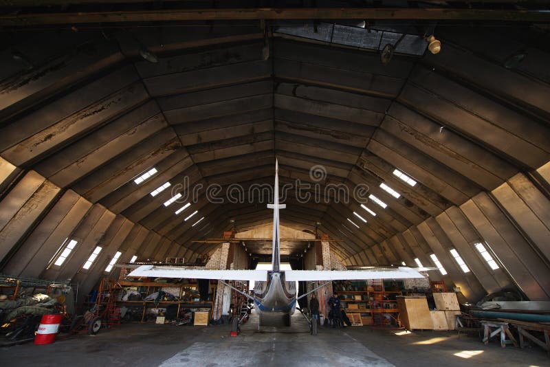 Hangar with Modern Airplane Inside. Editorial Stock Image - Image of ...