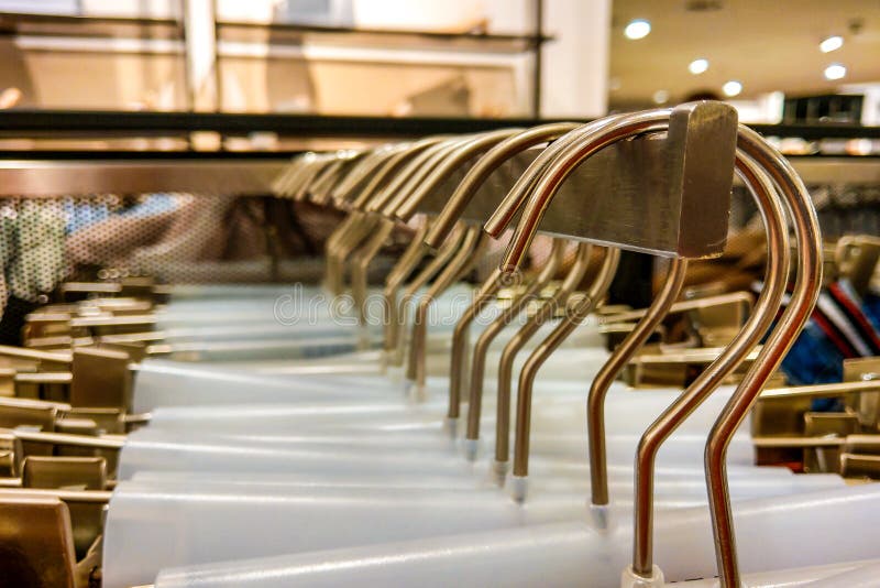Hangers with Clothes in a Row in the Store. Things on Hangers Stock ...