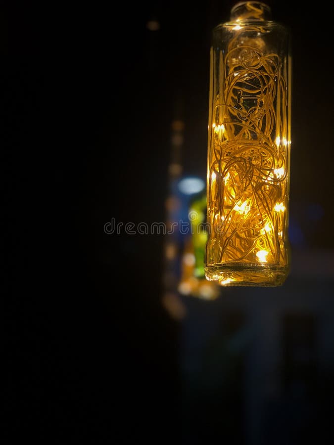 Hanging Glass Bottles with Lights Inside Stock Photo - Image of glass ...