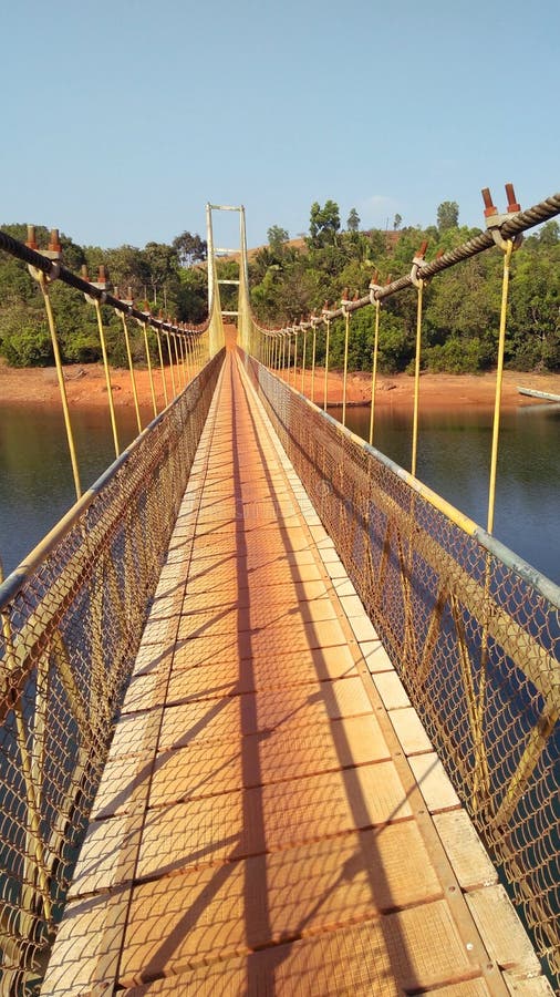 Bridge with Brown Guardrails Overlooking a River and Abundant Trees ...