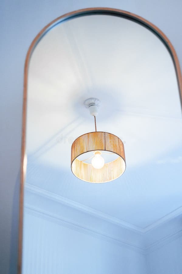 Hanging Ceiling Lamp Inside Round Decorated Frame Reflecting on a ...