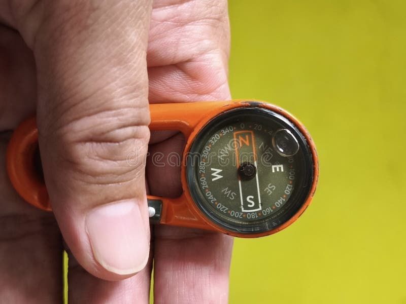 A hanging compass in hand stock photo. Image of decisions - 376620648