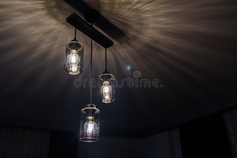 Hanging Dangling Ceiling Scones in Front of a Dark Background Stock ...