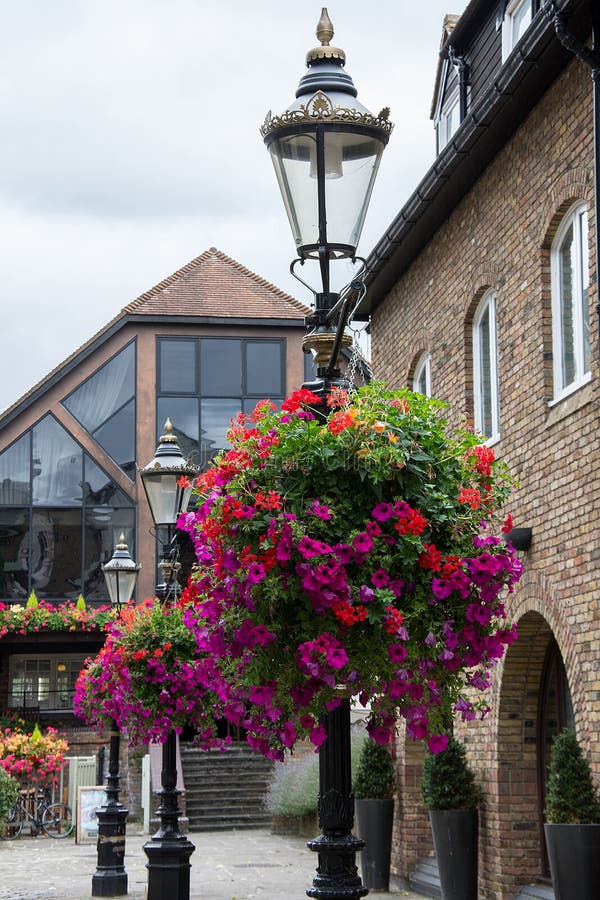 Flower Baskets Hanging on the Railing of a Bridge Stock Photo - Image ...