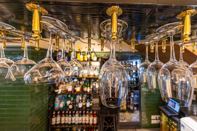 Hanging Glasses in a Bar with Bottles of Stock Image - Image of elegant ...