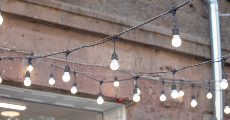 Hanging Light Bulbs in the Street Stock Image - Image of cable ...