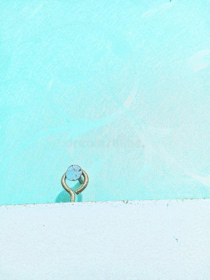 A Hanging Object on Metallic Hook in Textured Background Stock Photo ...