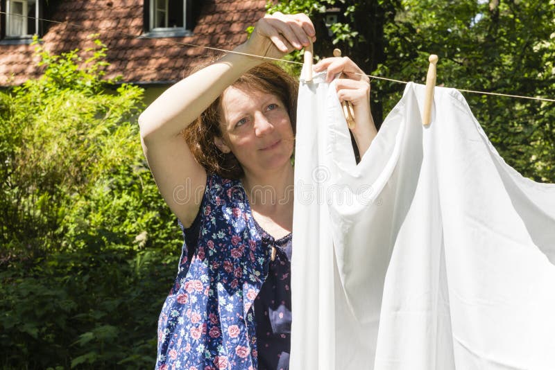 Hanging up the washing stock image. Image of outdoors - 53569403
