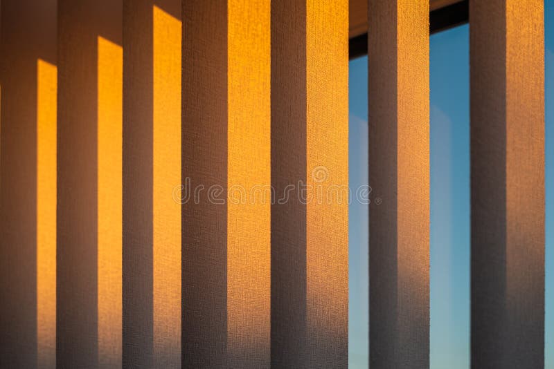 Hanging White Textured Vertical Window Slats Reflecting the Gold of a ...