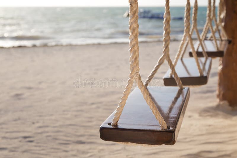 Hanging Wooden Swing Seats at a Bar on the Beach. Stock Photo - Image ...