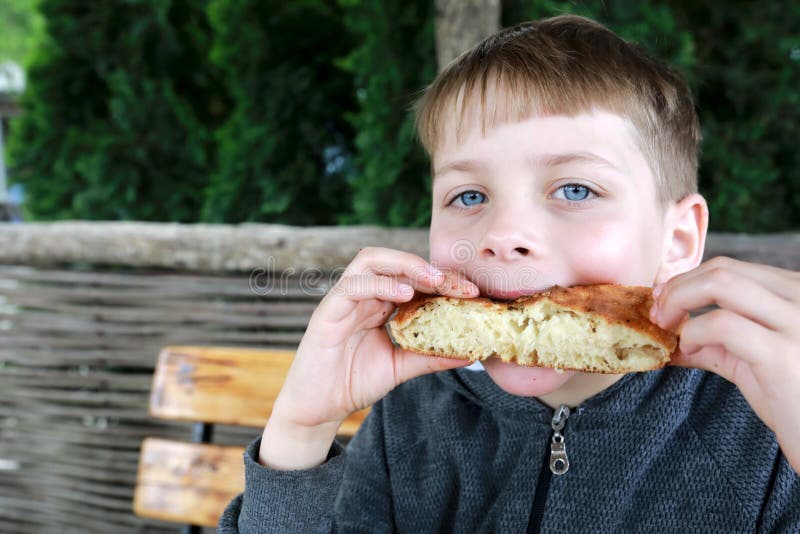 Hangry child eating bread stock image. Image of lunch - 255554593