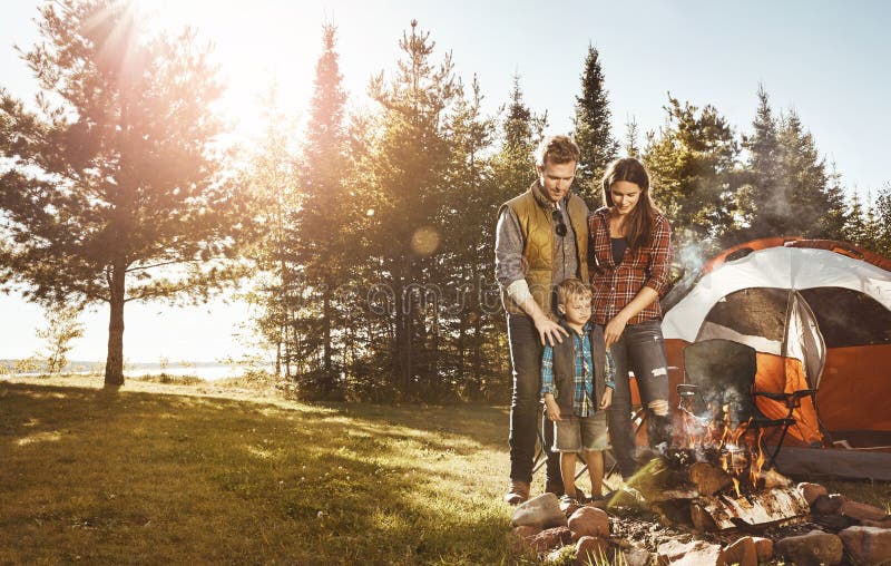 Happily Camping with Family. a Young Family Camping in the Forest ...