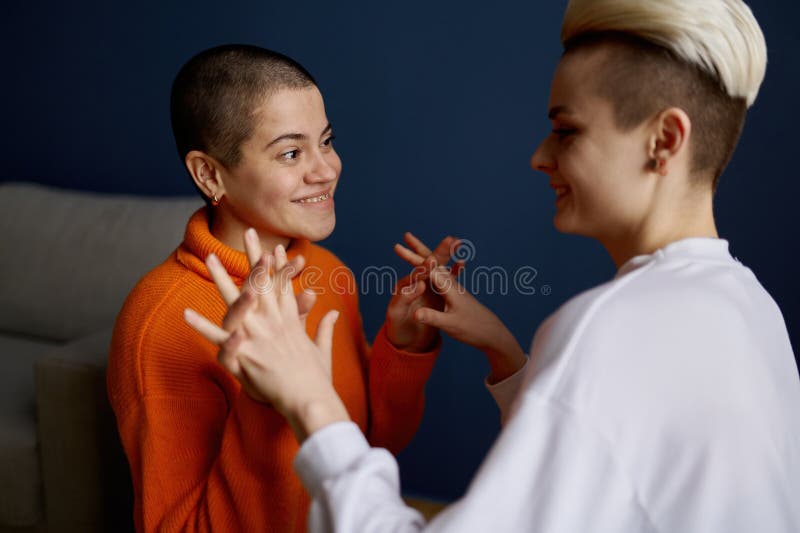 Romantic Lesbian Couple Standing Face To Face Holding Hands Stock