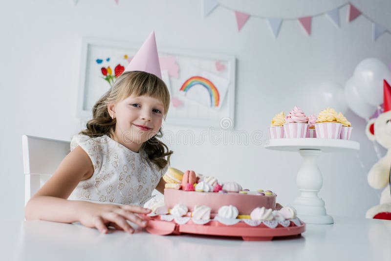 Happy Adorable Child in Cone Sitting at Table with Birthday Stock Image ...
