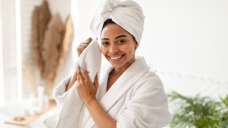 Happy African American Female Drying Face With Towel In Bathroom Stock