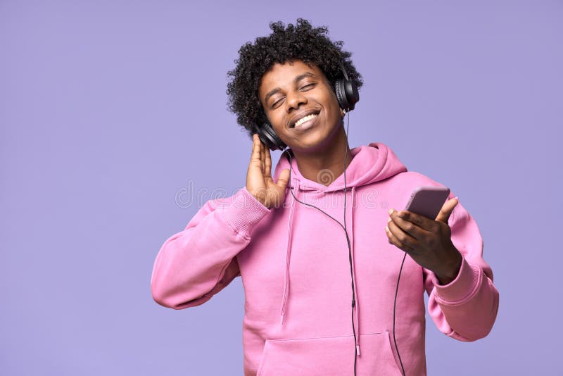 Happy African American Guy Wearing Headphones Holding Mobile Listening