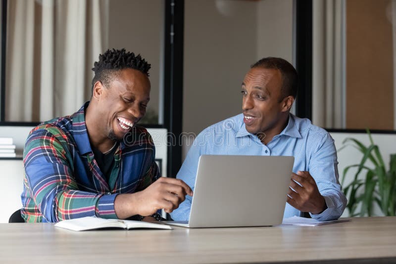 Happy African American Male Employees Working on Computer. Stock Photo ...