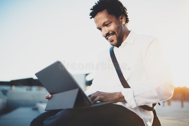 Smiling Young African American Man Sending Email Via Electronic Touch ...