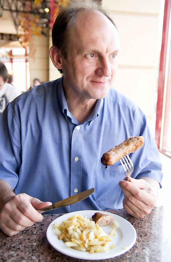 Happy aged man eating stock photo. Image of breakfast - 27153432