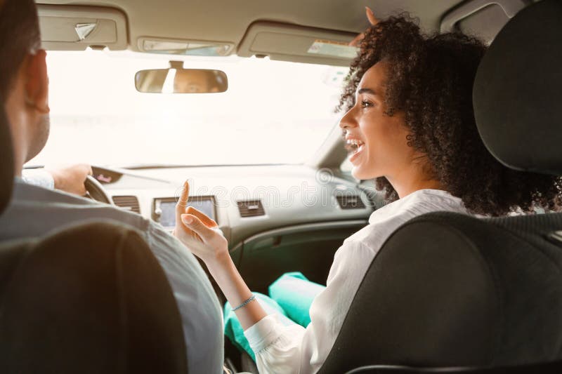 Happy Arab Couple Sitting In Car And Singing Rear View Stock Image