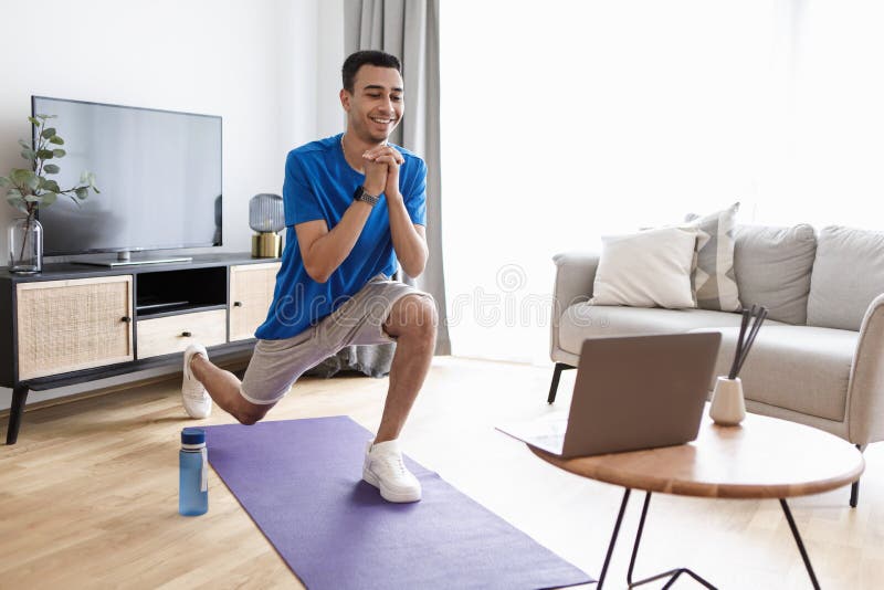 Happy Arab Man Doing Forward Lunge Exercises while Watching Online ...