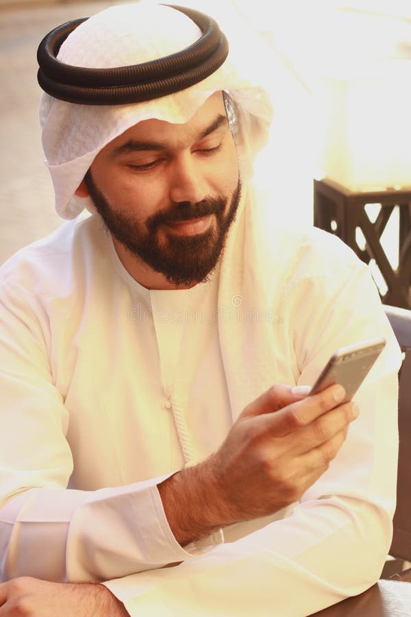 Happy Arab Man Smiling Holding Mobile Technology Stock Photo - Image of ...