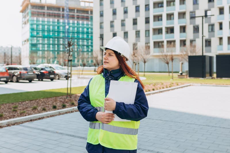 Happy Architect with Paper Folder with Documents at a Construction Site ...