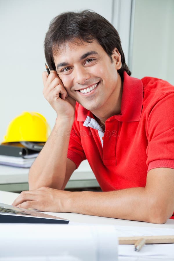 Happy Architect Sitting by Desk Stock Image - Image of male, handsome ... Happy Architect Sitting by Desk Stock Image - Image of male, handsome ...