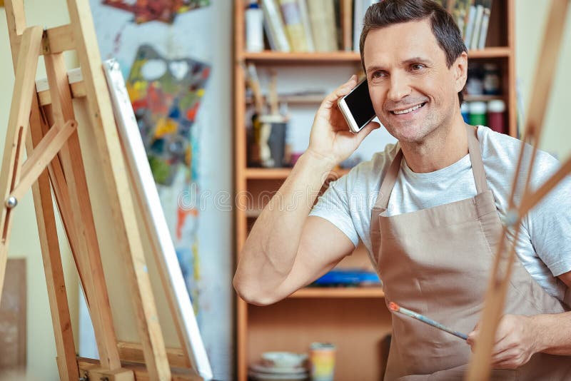 Happy Artist Talking on Cellphone in Painting Studio Stock Photo ...