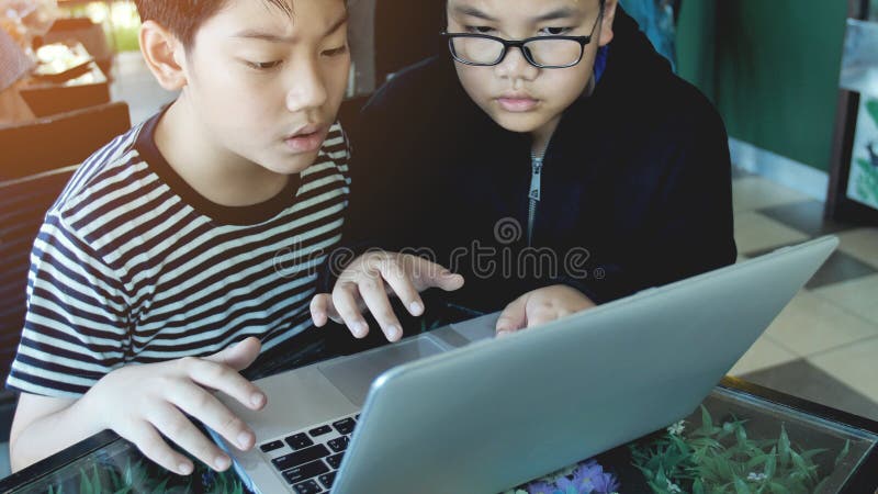 Happy Asian Boy Typing on Laptop Computer. Stock Photo - Image of ...