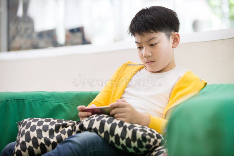 Happy Asian Boy Using Cell Phone with Smile Face . Stock Photo - Image ...