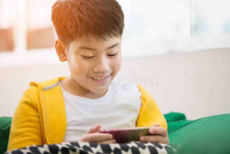 Happy Asian Boy Using Cell Phone with Smile Face . Stock Image - Image ...