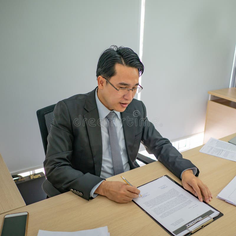 Happy Asian Business Man Look at His Document File in the Office Stock ...
