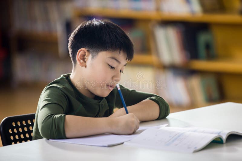 Happy Asian Child Doing Homework with Smile Face. Stock Photo - Image ...