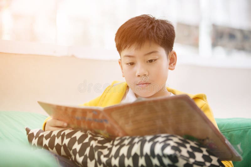 Happy Asian Child Reading Book with Smile Face. Stock Photo - Image of ...
