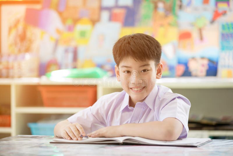 Happy Asian Child Reading Book with Smile Face. Stock Photo - Image of ...