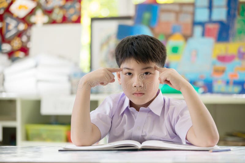 Happy Asian Child Reading Book and Thinking about that Stock Photo ...